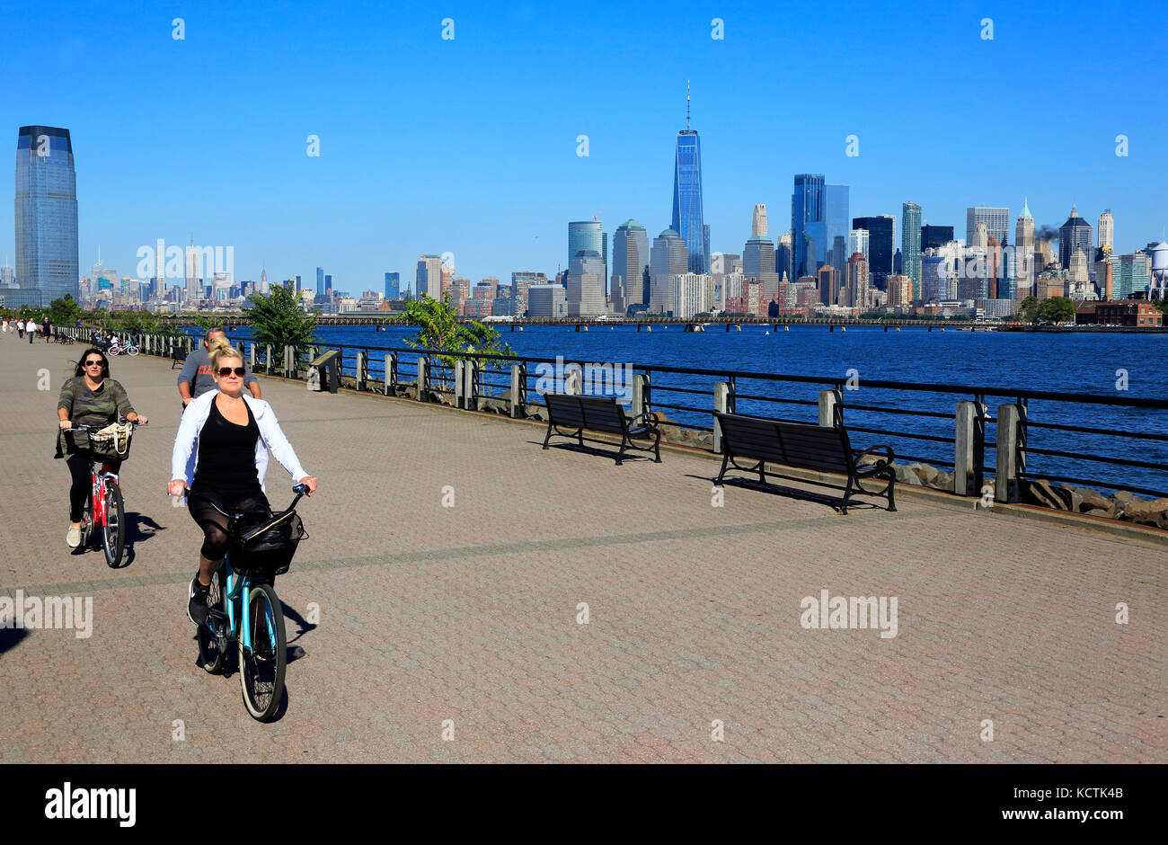Women biking on the Hudson river Waterfront Walkway with Goldman Sachs ...