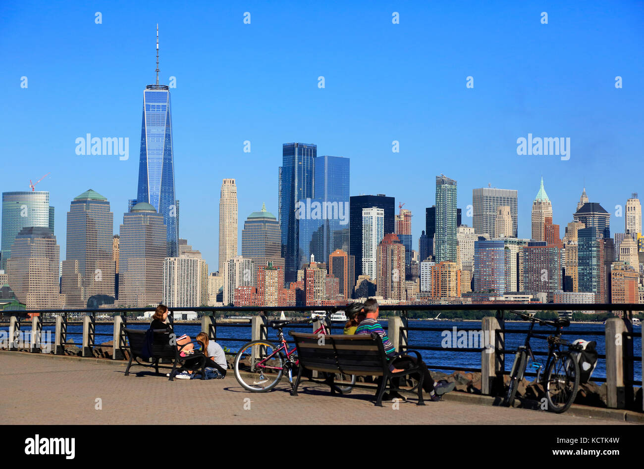 Visitors relaxing on the Hudson River Waterfront Walkway with skyline ...