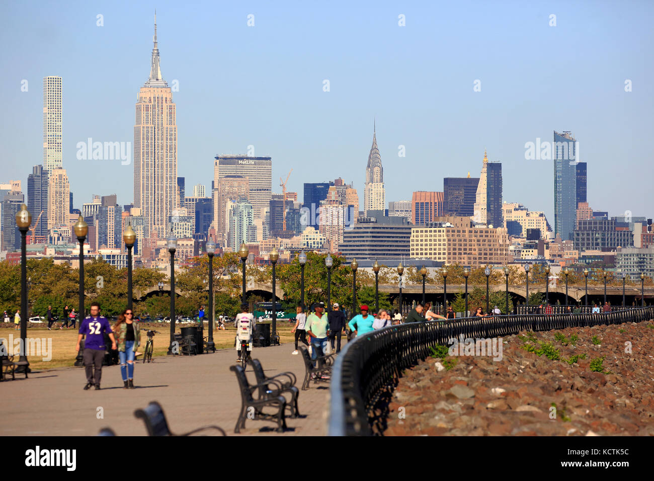 Visitors at Hudson River Waterfront Walkway in Liberty State Park with Midtown Manhattan NYC ...