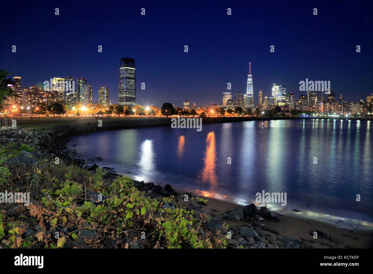 the night view of the skyline of Jersey City and Lower Manhattan with ...