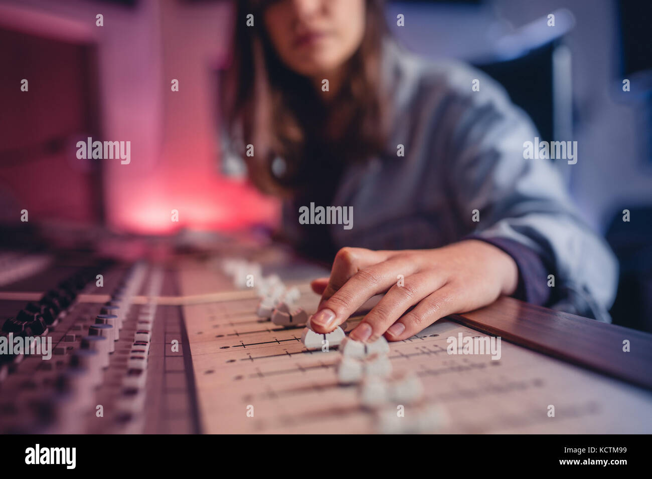 Woman hands mixing audio in recording studio. Female hands working on ...