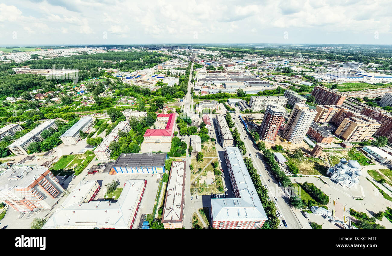 Aerial city view with crossroads and roads, houses, buildings, parks ...