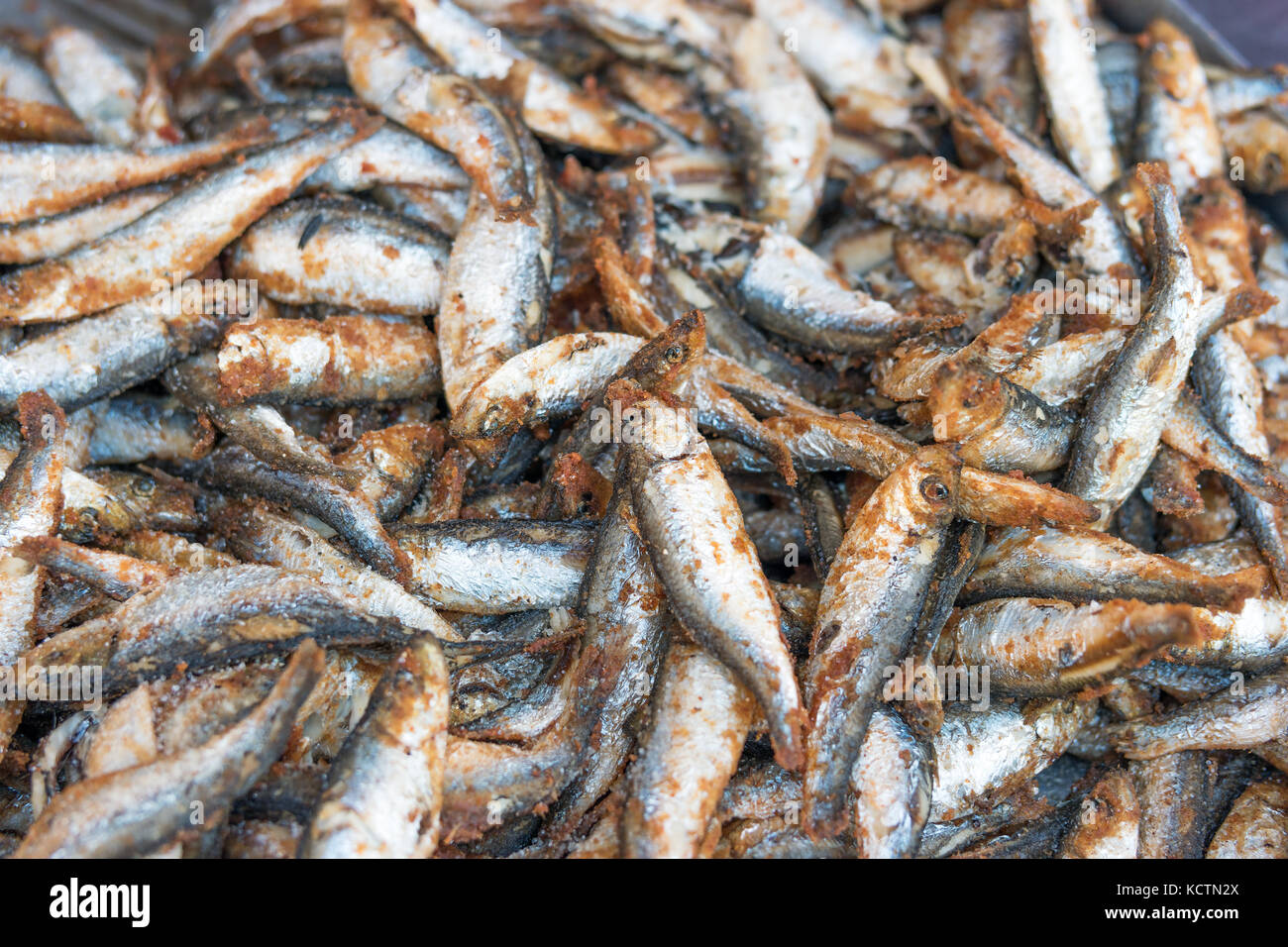 Fried small fish on a fair stall, selective focus Stock Photo - Alamy