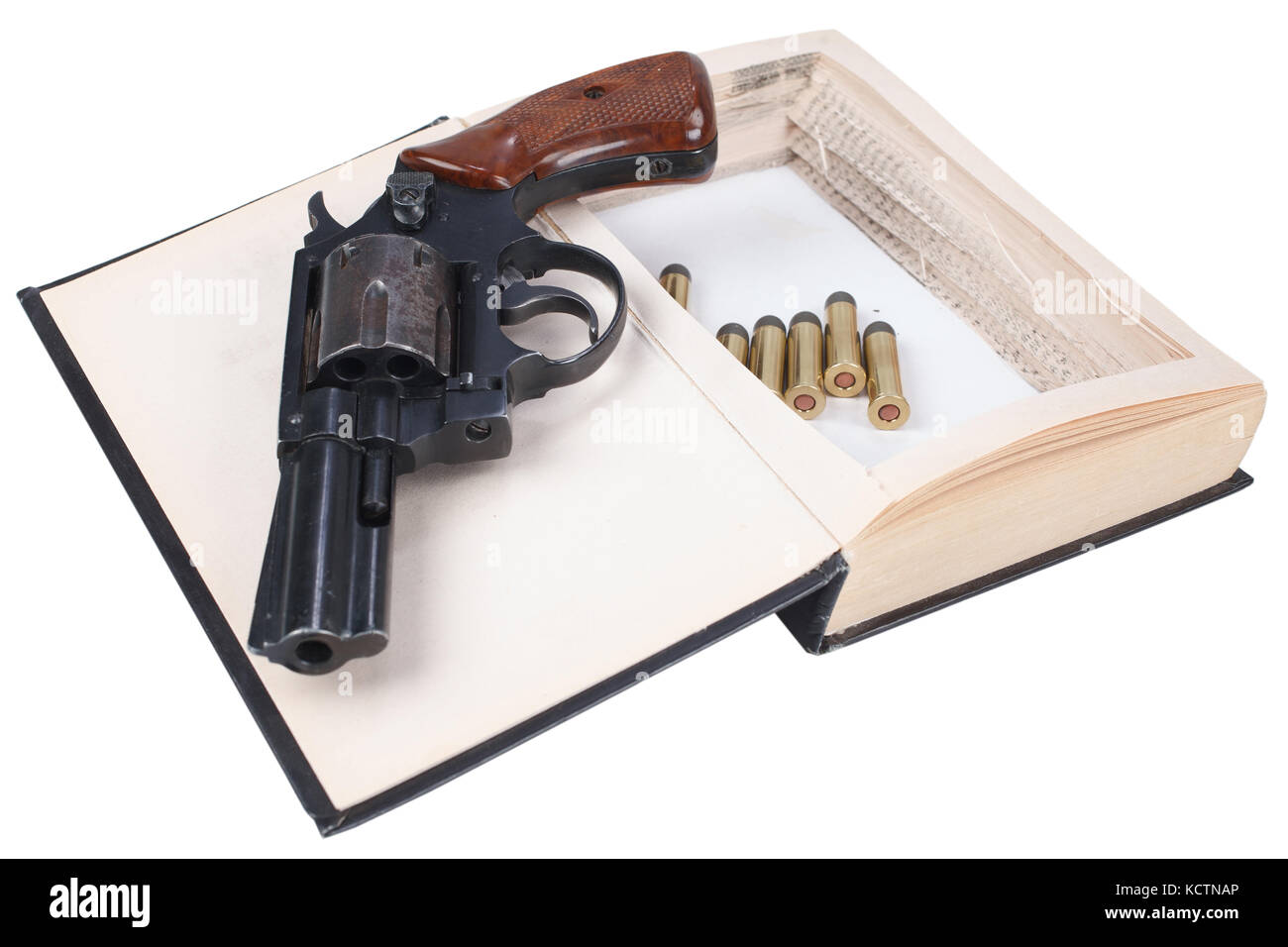 Revolver gun with cartridges hidden in a book Stock Photo - Alamy