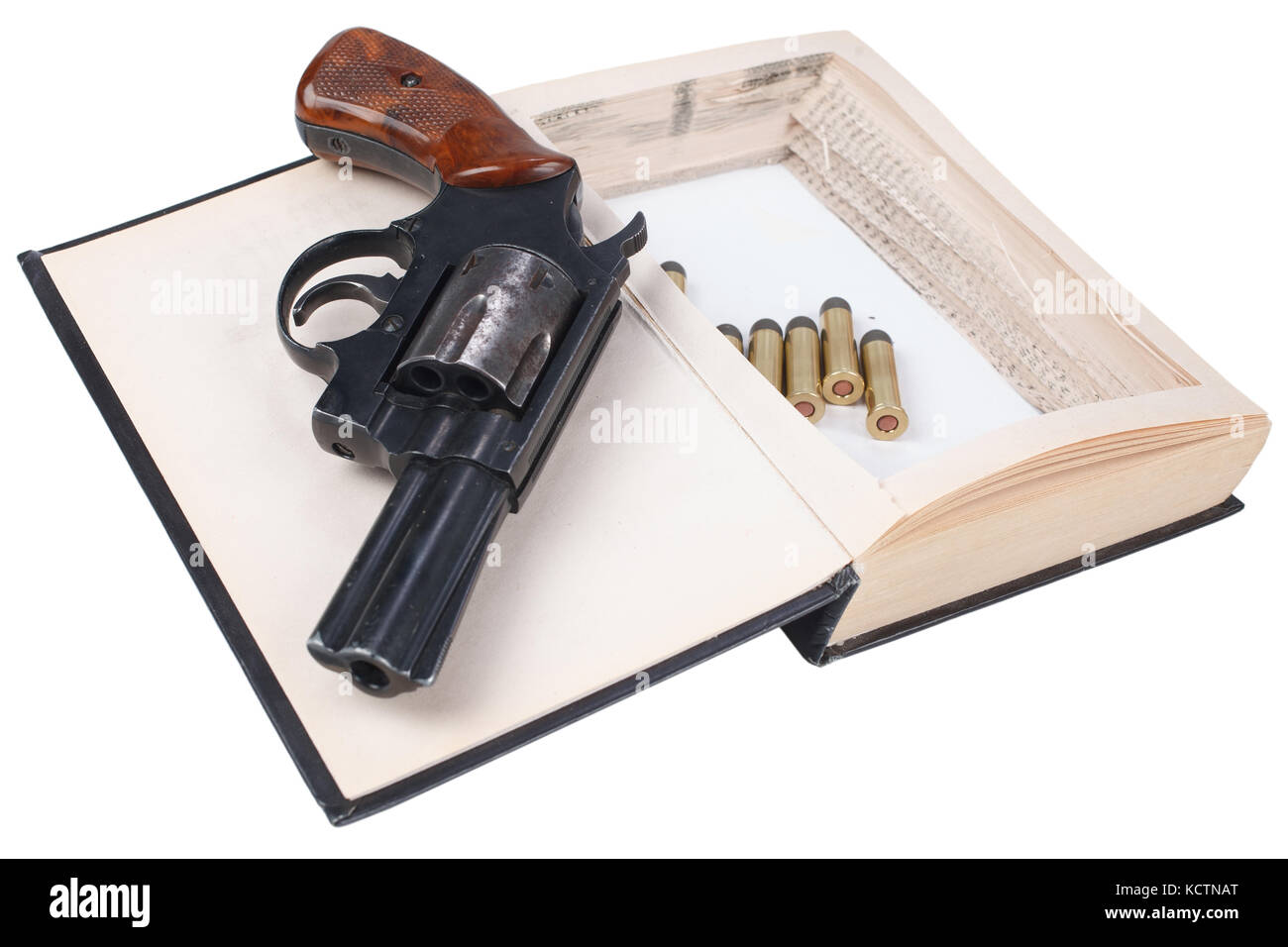 Revolver gun with cartridges hidden in a book Stock Photo - Alamy