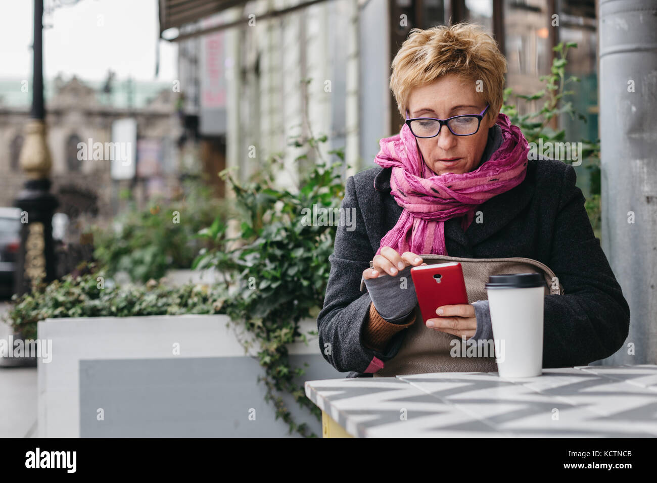 Adult woman surfing phone Stock Photo - Alamy
