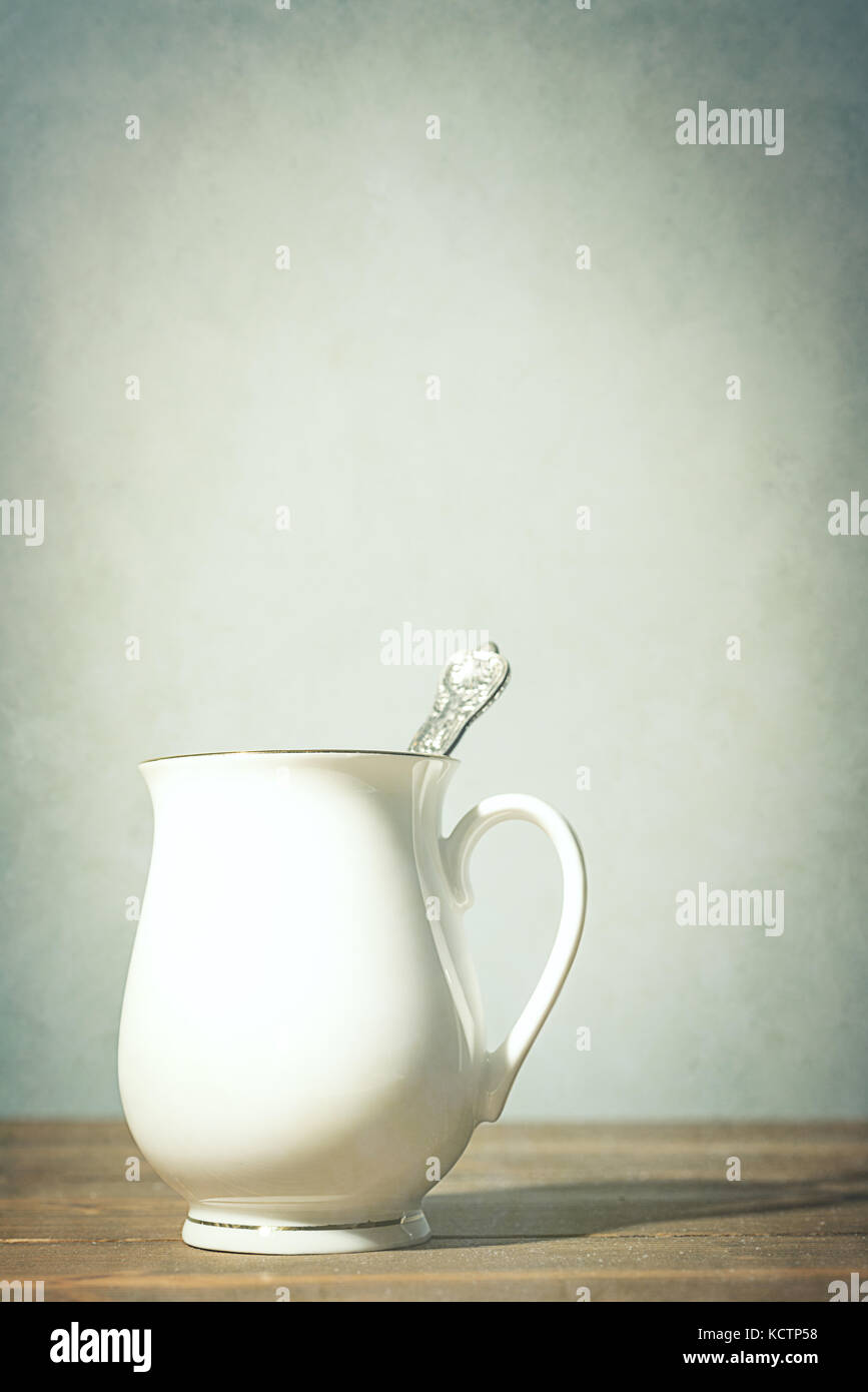 Coffee cup with spoon on wooden table Stock Photo - Alamy