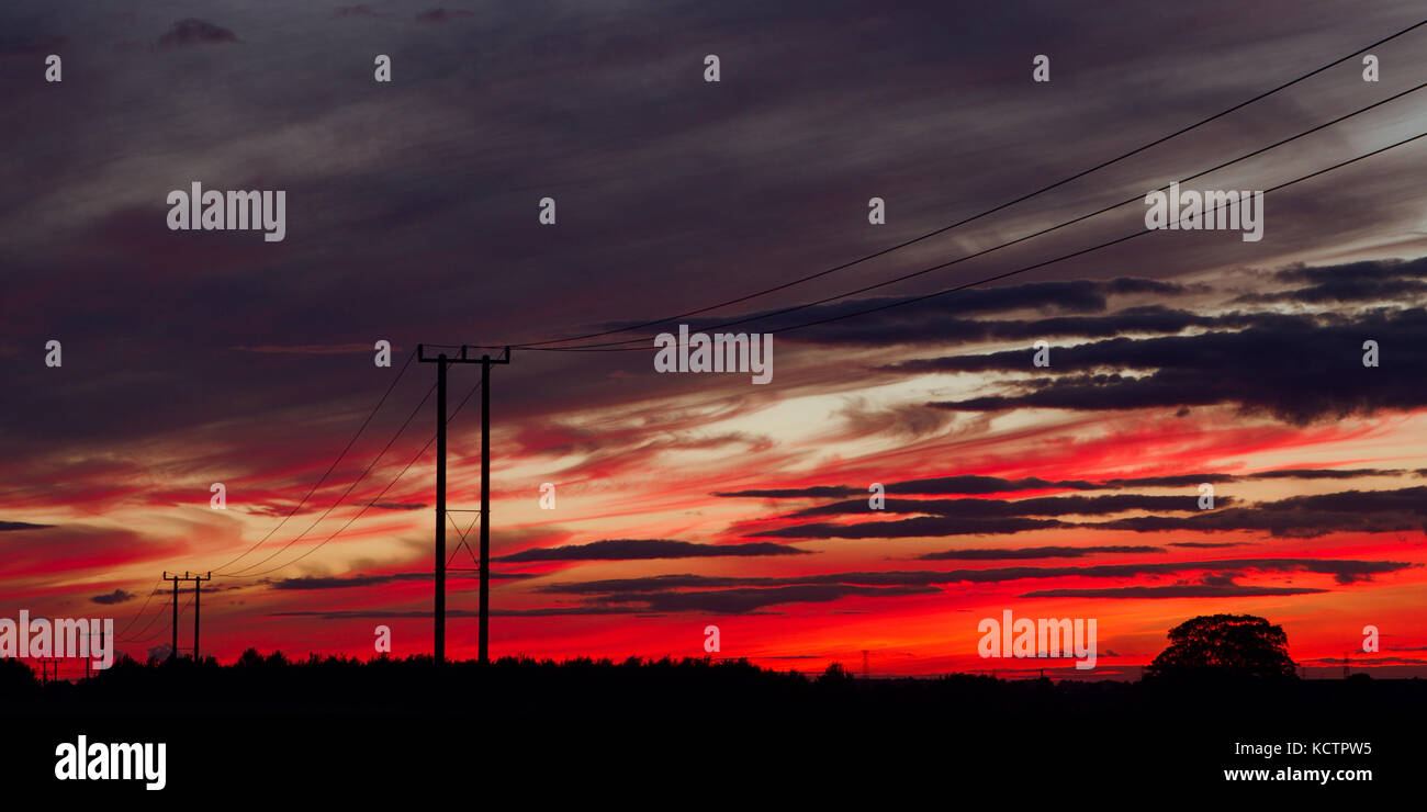 Red sunset with telegraph poles Stock Photo - Alamy