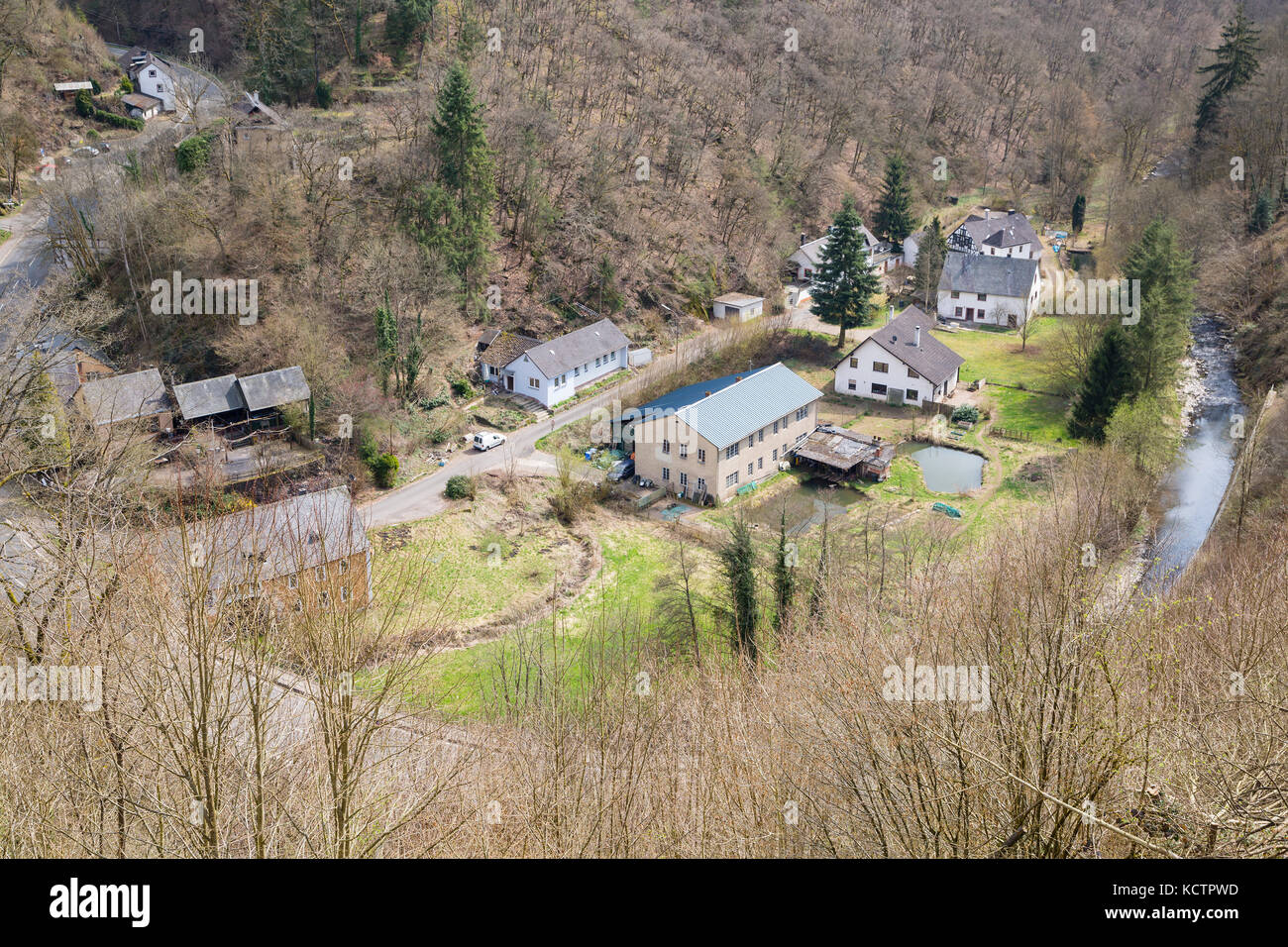 Eifel valley in Manderscheid, Germany in spring with a river and a few ...