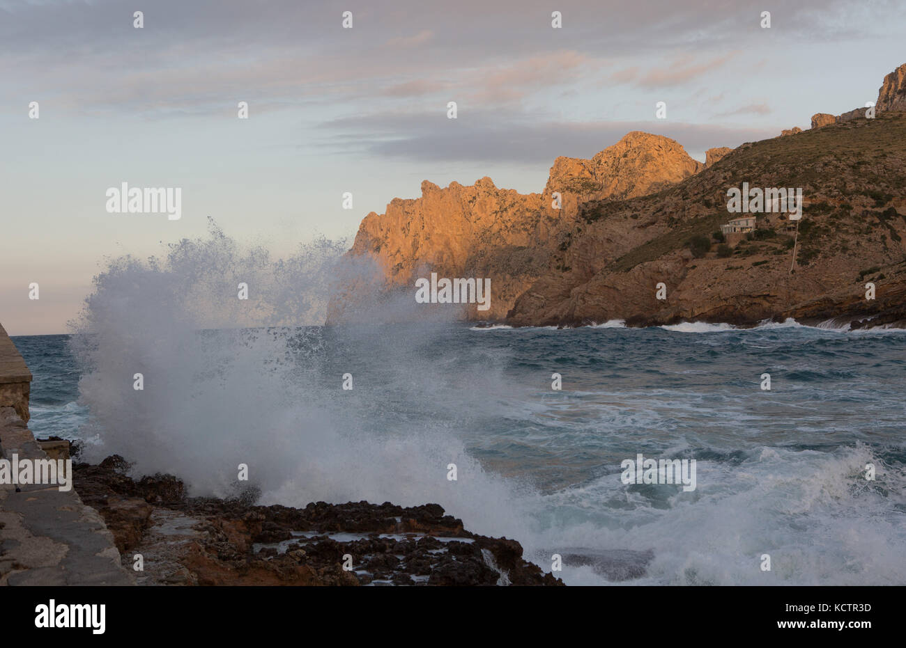 Wave splashing on rock at shore during sunset, Cala San Vicente ...