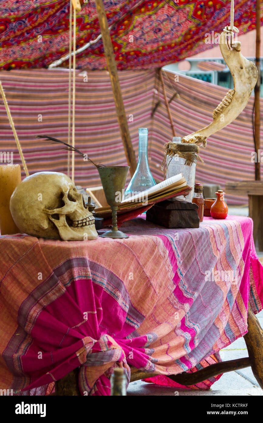 table with potions, books and skull of medieval times, witchcraft and ...