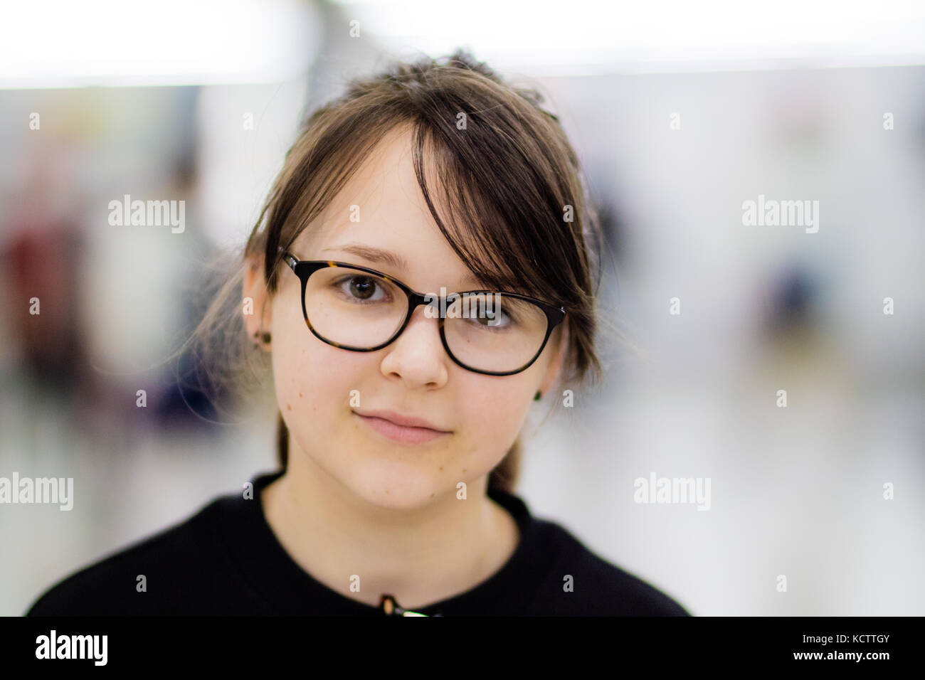 A Beautiful Young Girl Wearing Glasses Smiling For A Portrait With Copy