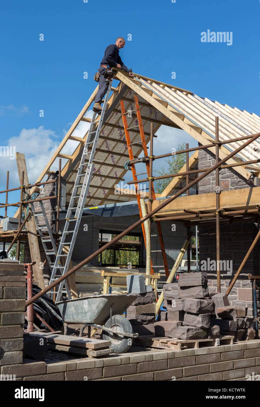 Man roofing on newbuild house, Abergavenny, Wales, UK Stock Photo - Alamy