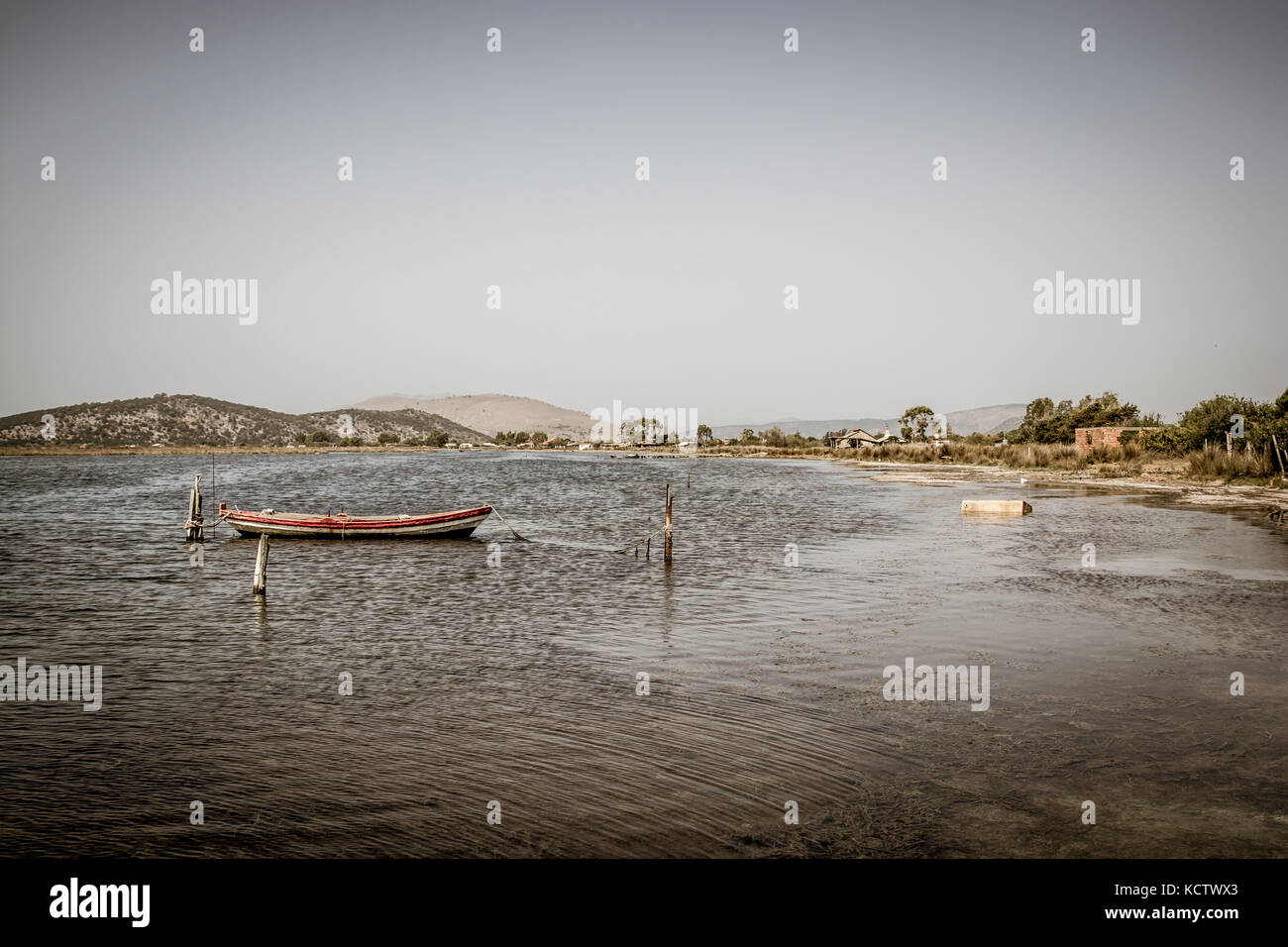 A fishing boat standing alone at the river mouth of Acheloos Stock ...