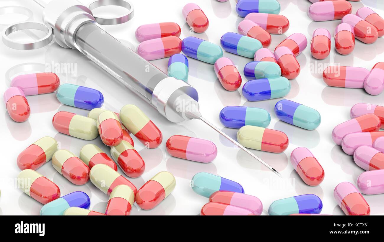 Colorful caplets and syringe, on white background Stock Photo - Alamy