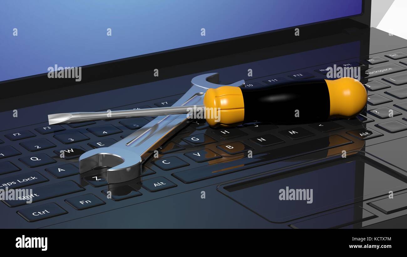 Screwdriver and wrench on laptops keyboard Stock Photo - Alamy