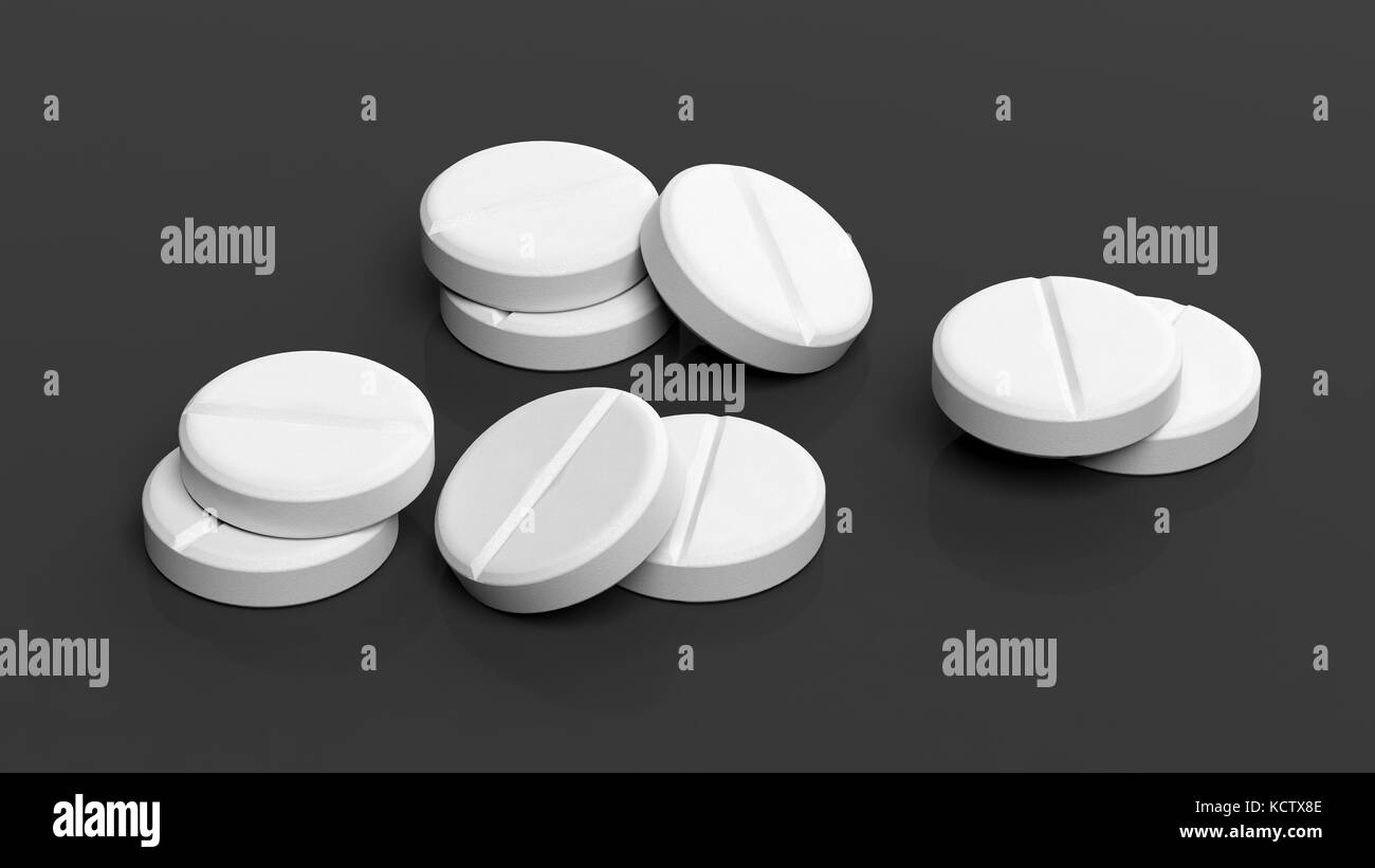 White round pills, isolated on black background Stock Photo - Alamy