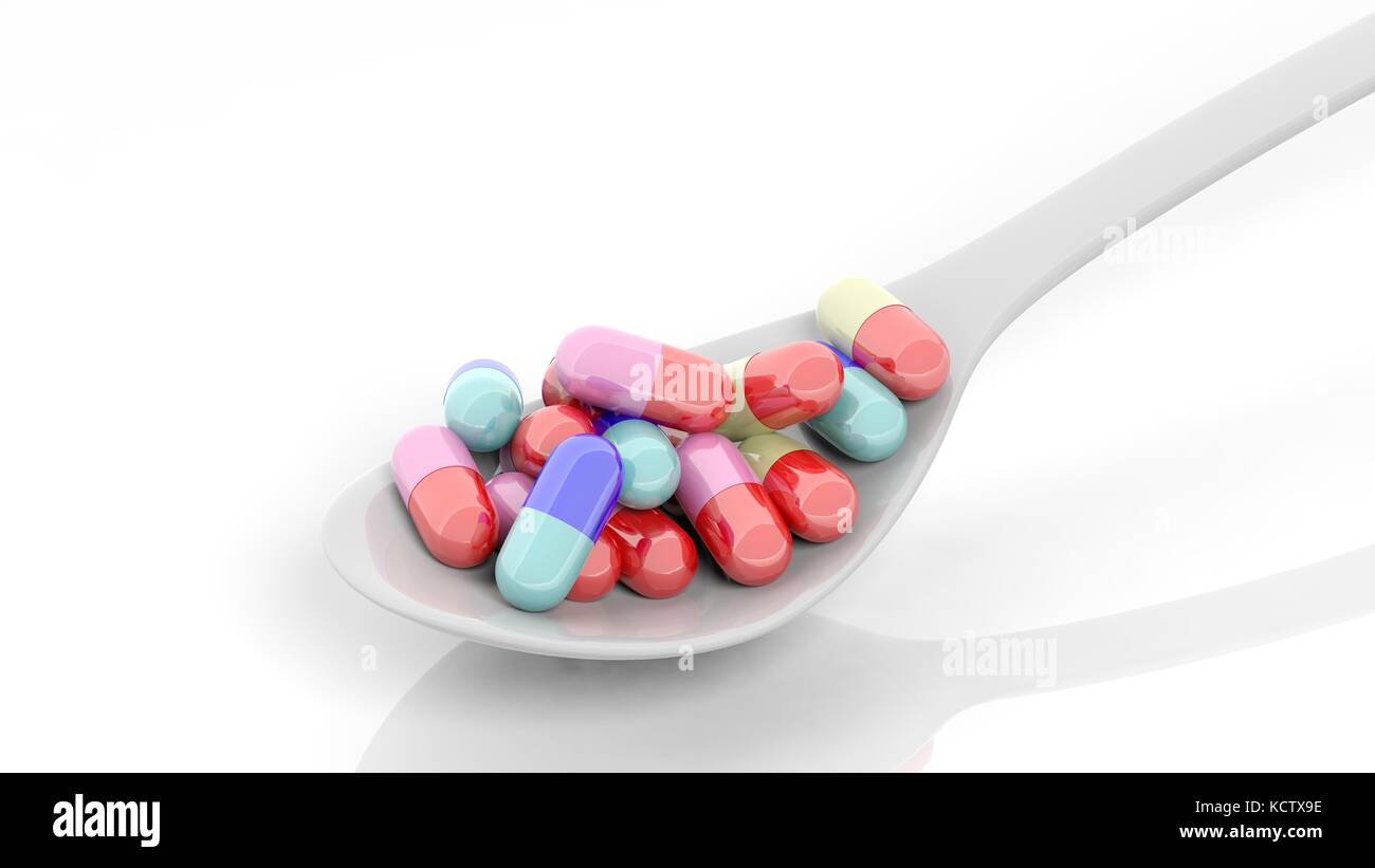 Colorful caplets inside a spoon, isolated on white background Stock ...