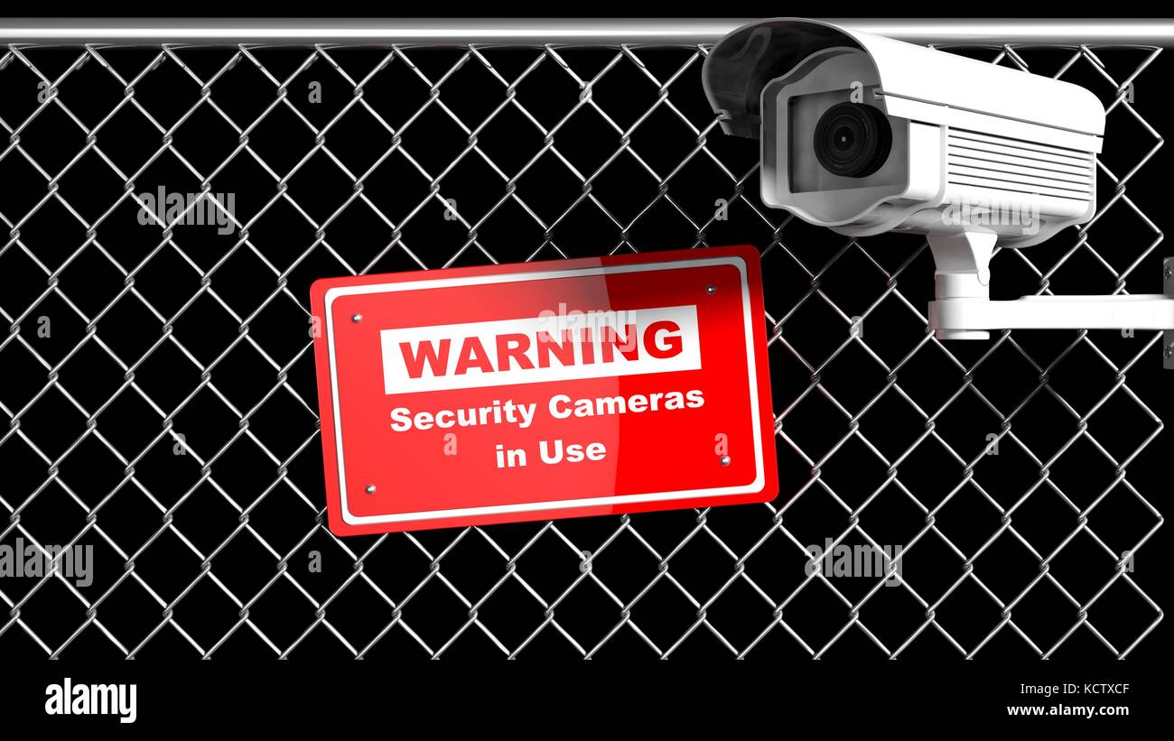 Security surveillance camera on chain-link fence with warning sign on ...