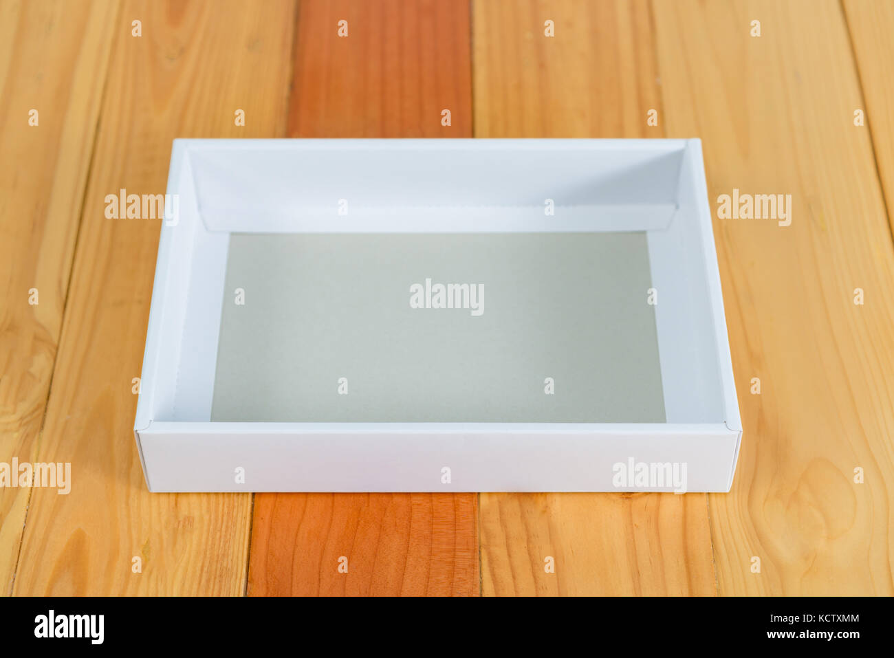 Empty white gift for mock up on bright wooden table with copy space ...