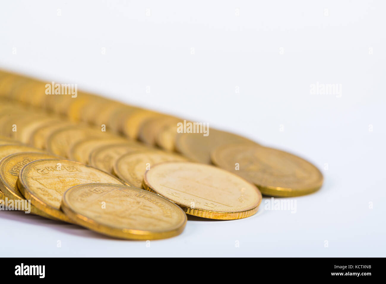 Columns of gold coins, piles of coins arranged on white background ...