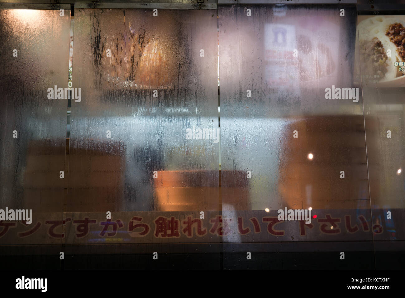 Horizontal night shot of bamboo bun steamers, neon signs and red ...