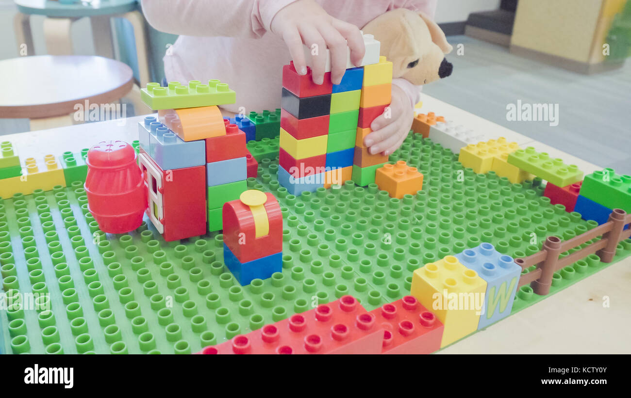 Toddler girl playing with building blocks Stock Photo - Alamy