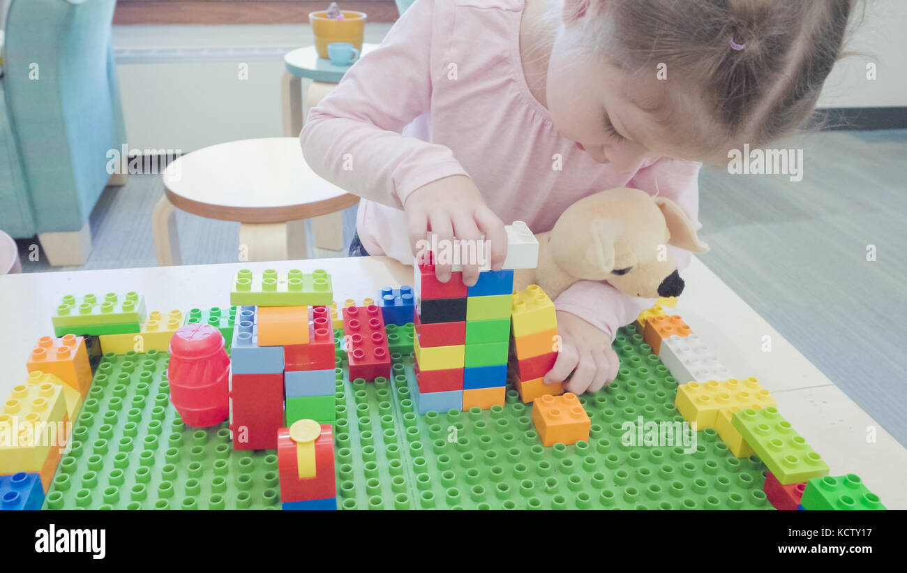 Toddler girl playing with building blocks Stock Photo - Alamy