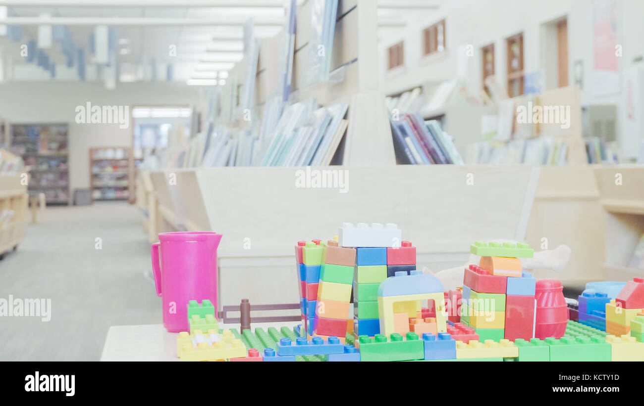 Table with colorful building blocks for toddlers Stock Photo - Alamy