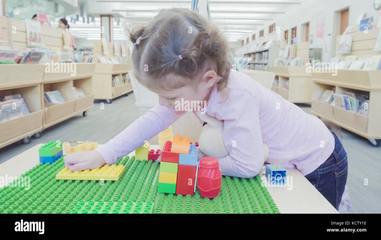 Toddler girl playing with building blocks Stock Photo - Alamy