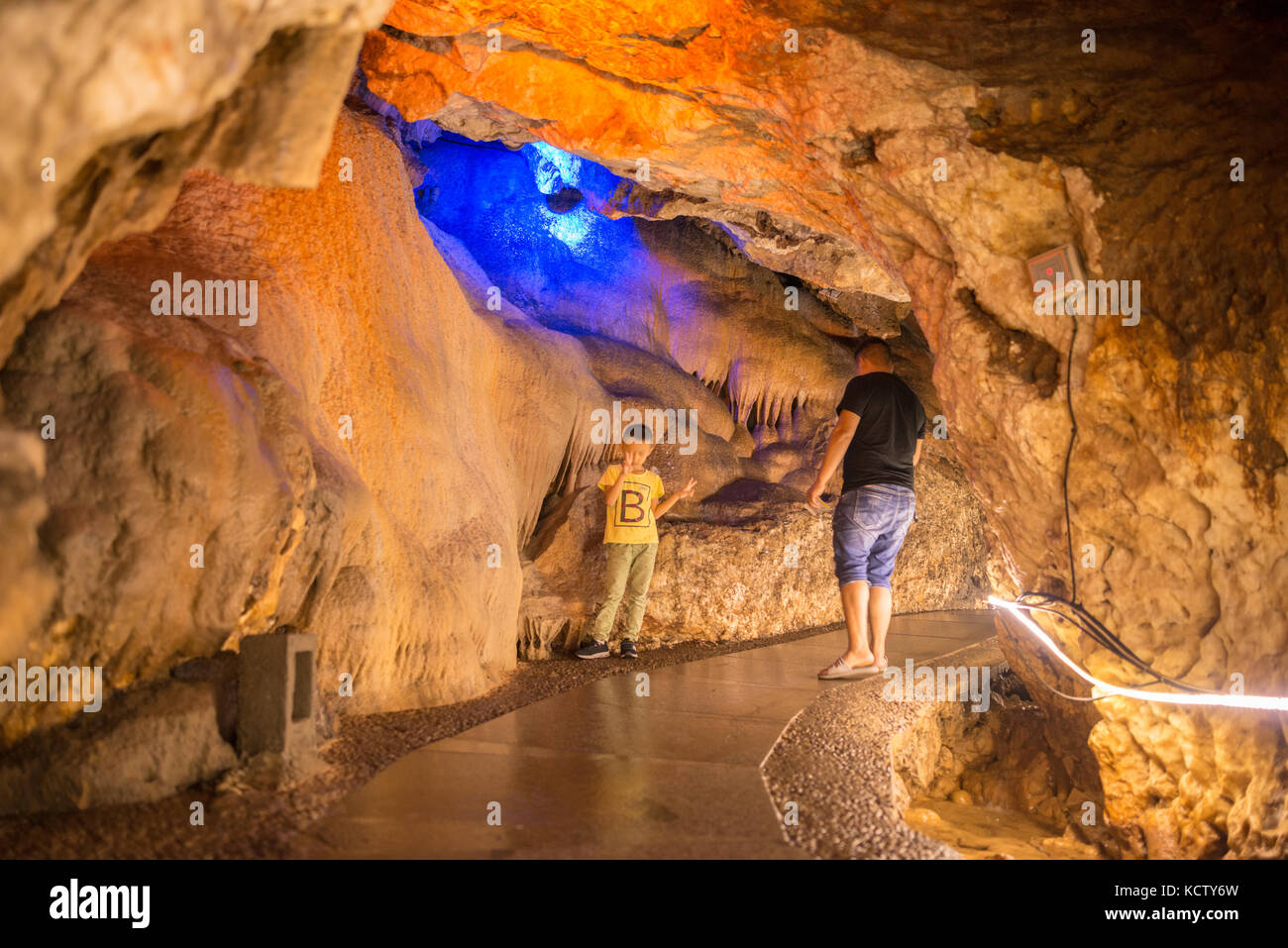 Underground illuminated caves in china Stock Photo - Alamy