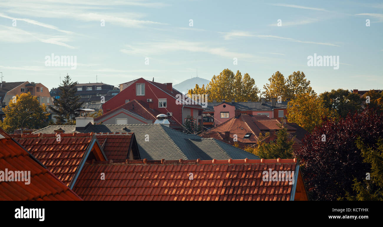 Autumn landscape of a small Balkan town, just colorful trees and roofs ...