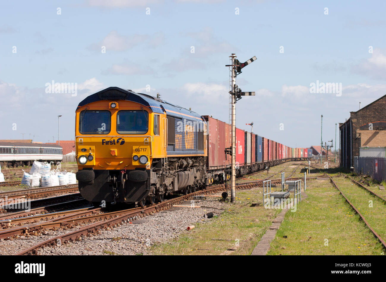 A GBRf class 66 diesel locomotive working an intermodal freight departs ...