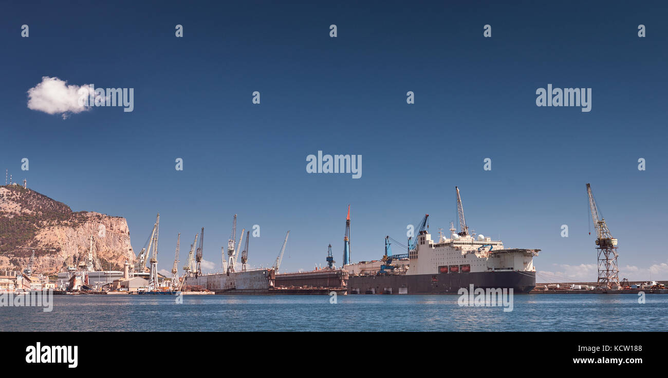 Harbor of Palermo, shipyard, harbor crane and ship, mountains in ...