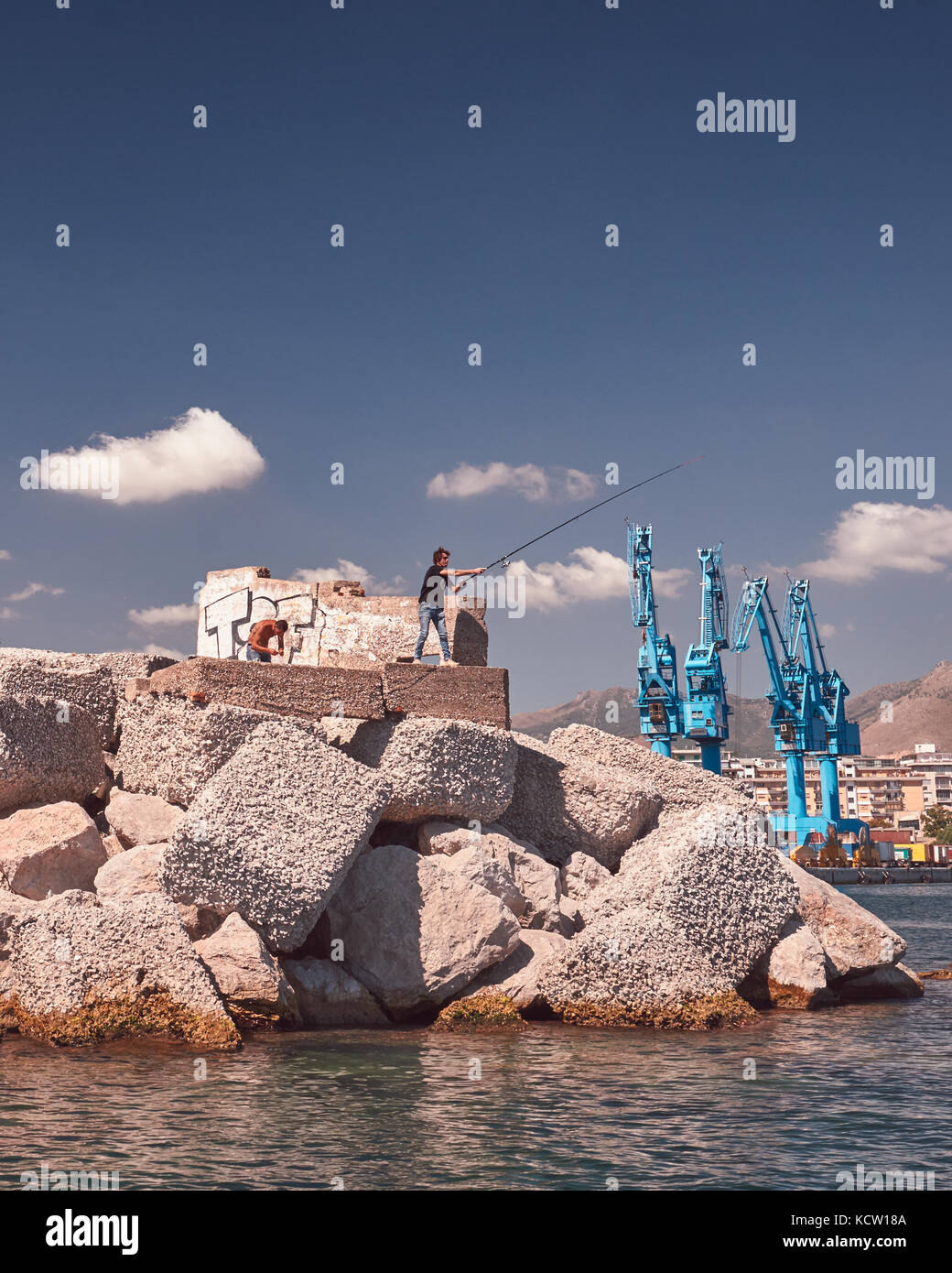 Palermo, Sicily, Italy, July 15 / 2017 Harbor of Palermo, men fishing ...