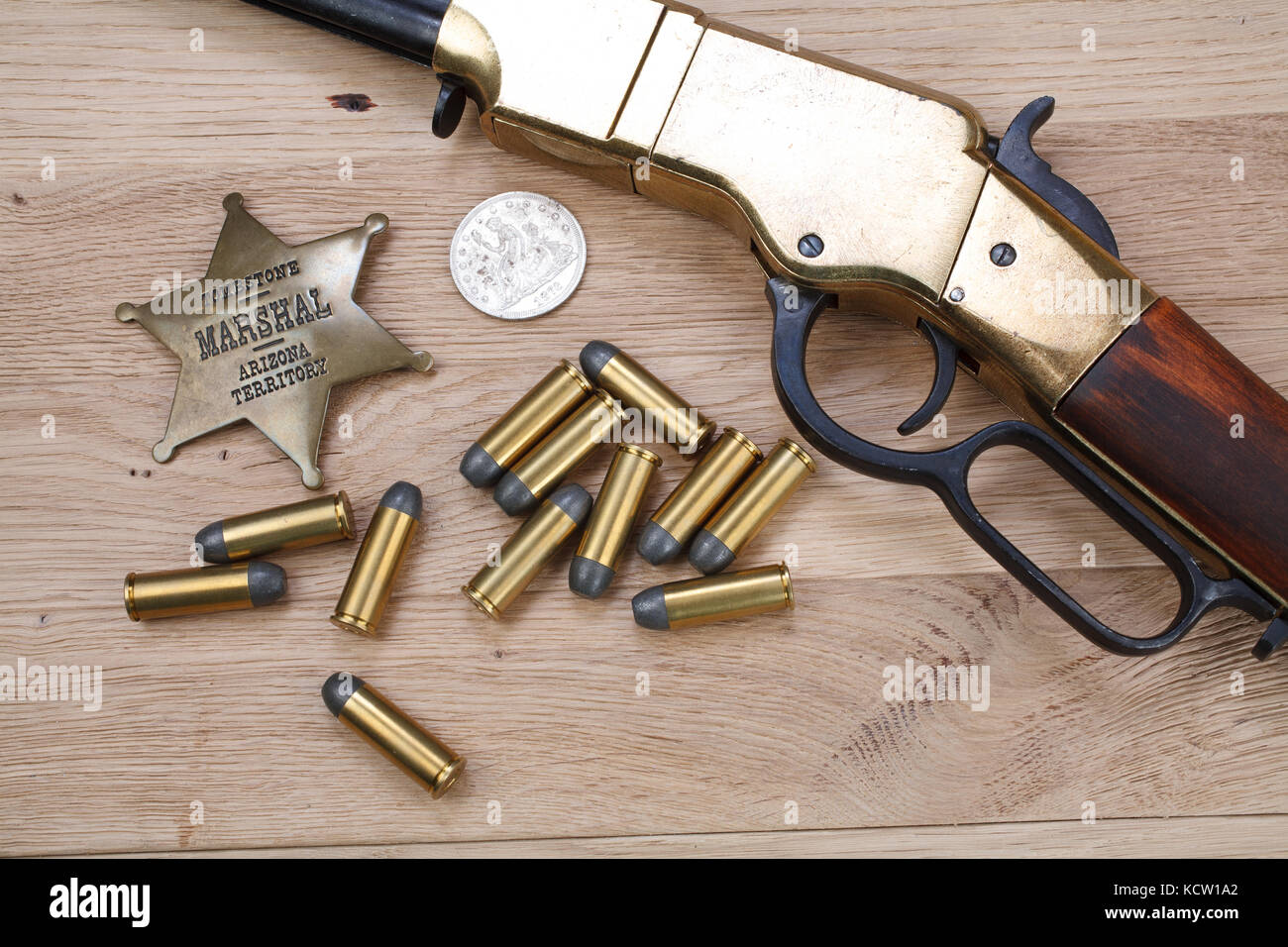 Wild west period repeating rifle with ammunition and sheriff badge ...