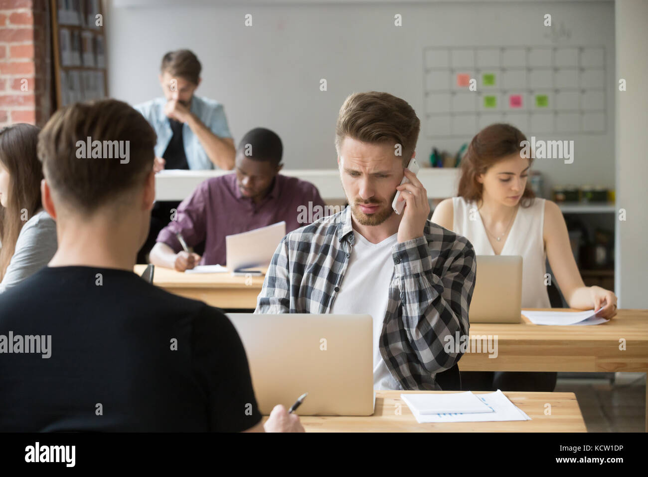 Worried manager having smartphone conversation hi-res stock photography ...