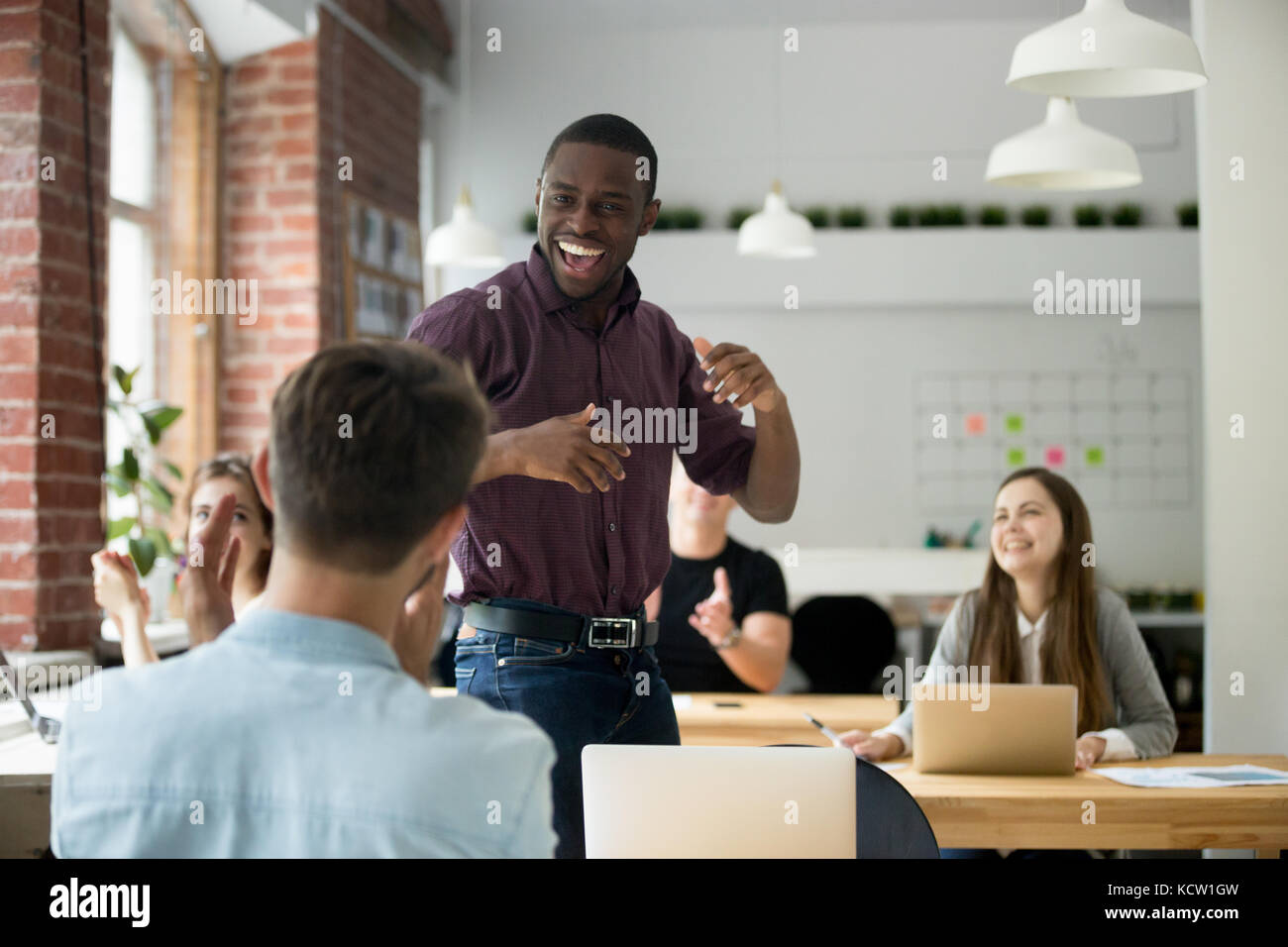 African american office worker dancing surrounded by colleagues. Happy ...