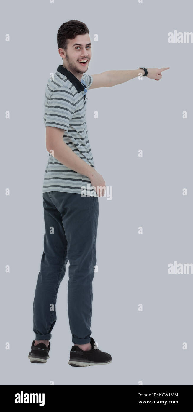 Young man pointing at something with his finger isolated on whit Stock ...