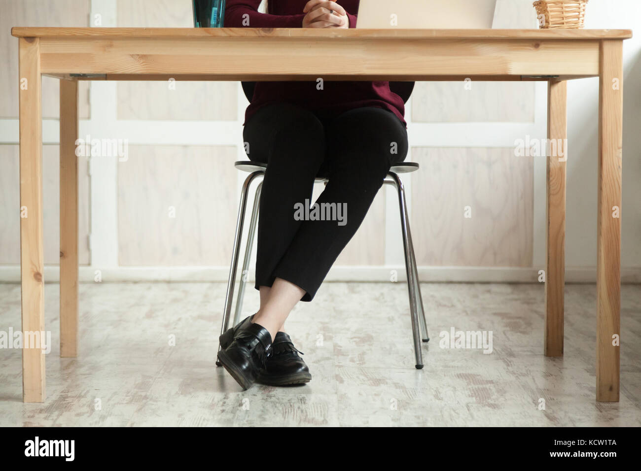 Close up legs of business lady at work desk anticipating meeting ...