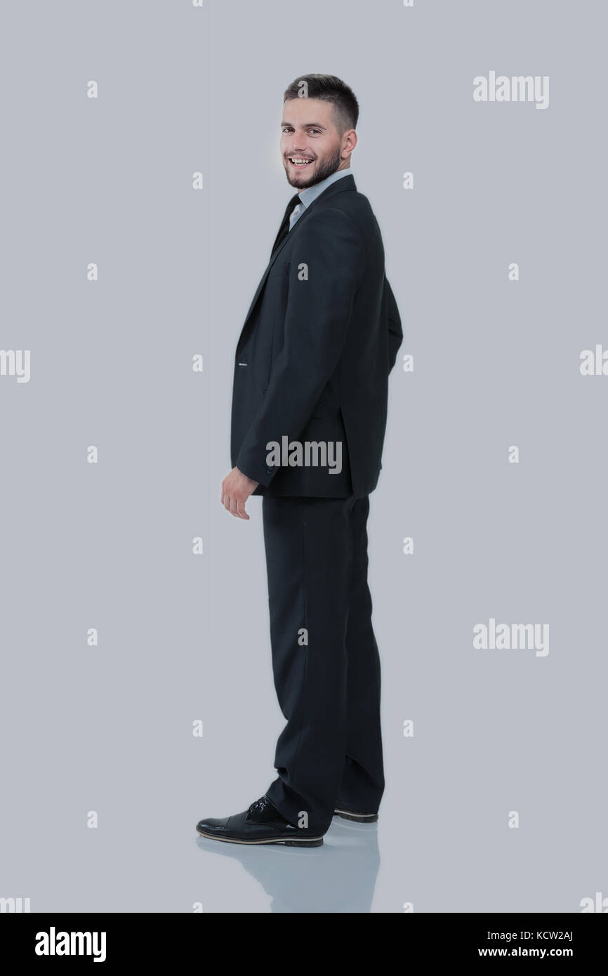 Portrait of a smiling business man standing in profile. Isolated on ...