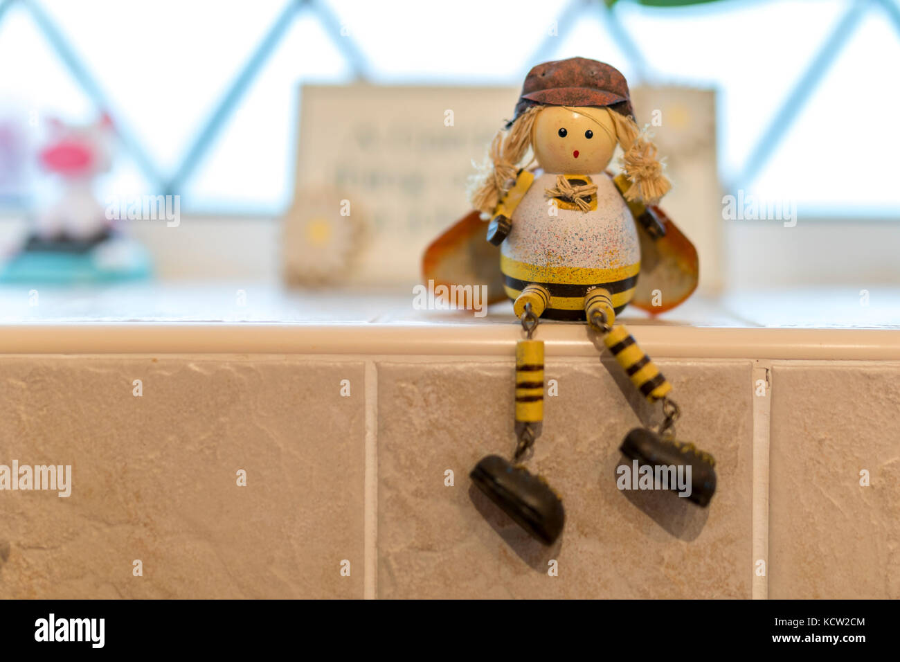 Cute tiny lady female bee artisan character ornament or toy sitting on ...