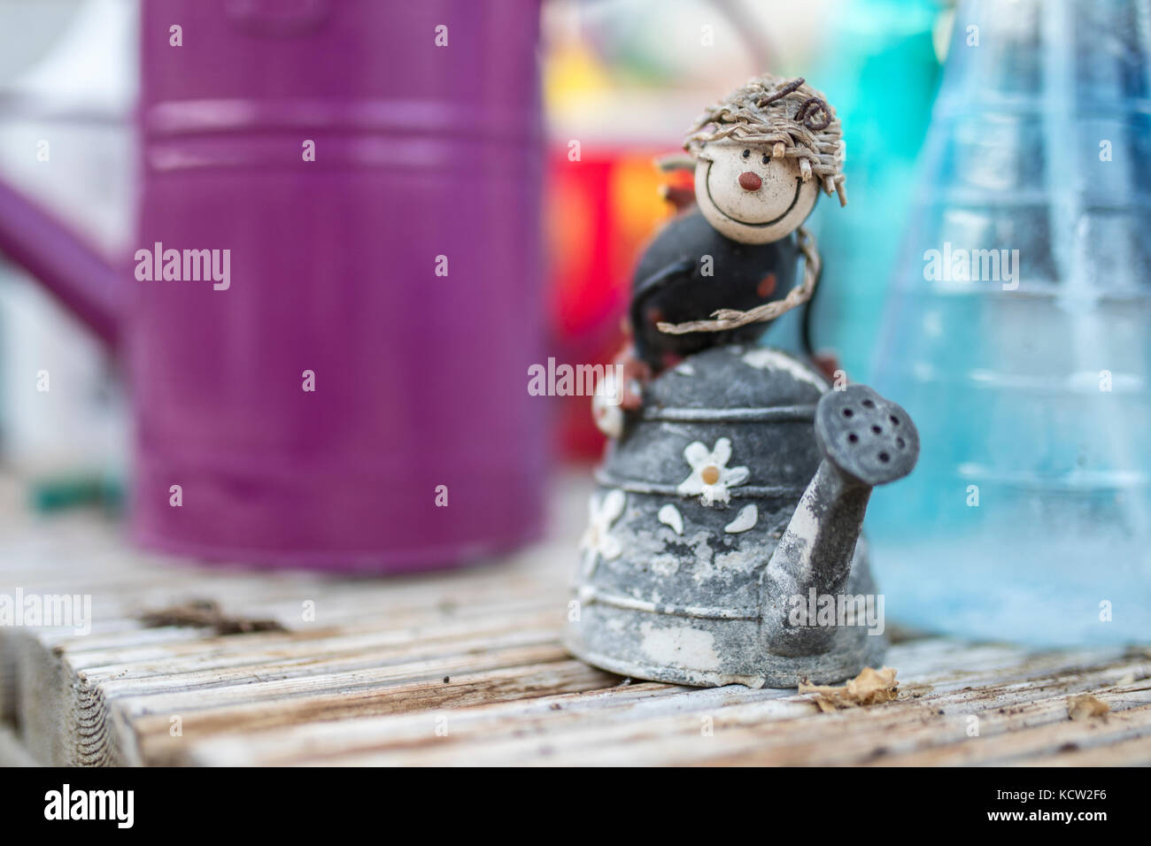 Quirky ornamental children’s character riding on a rustic flower ...