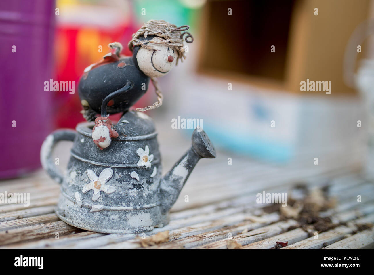 Quirky ornamental children’s character riding on a rustic flower ...