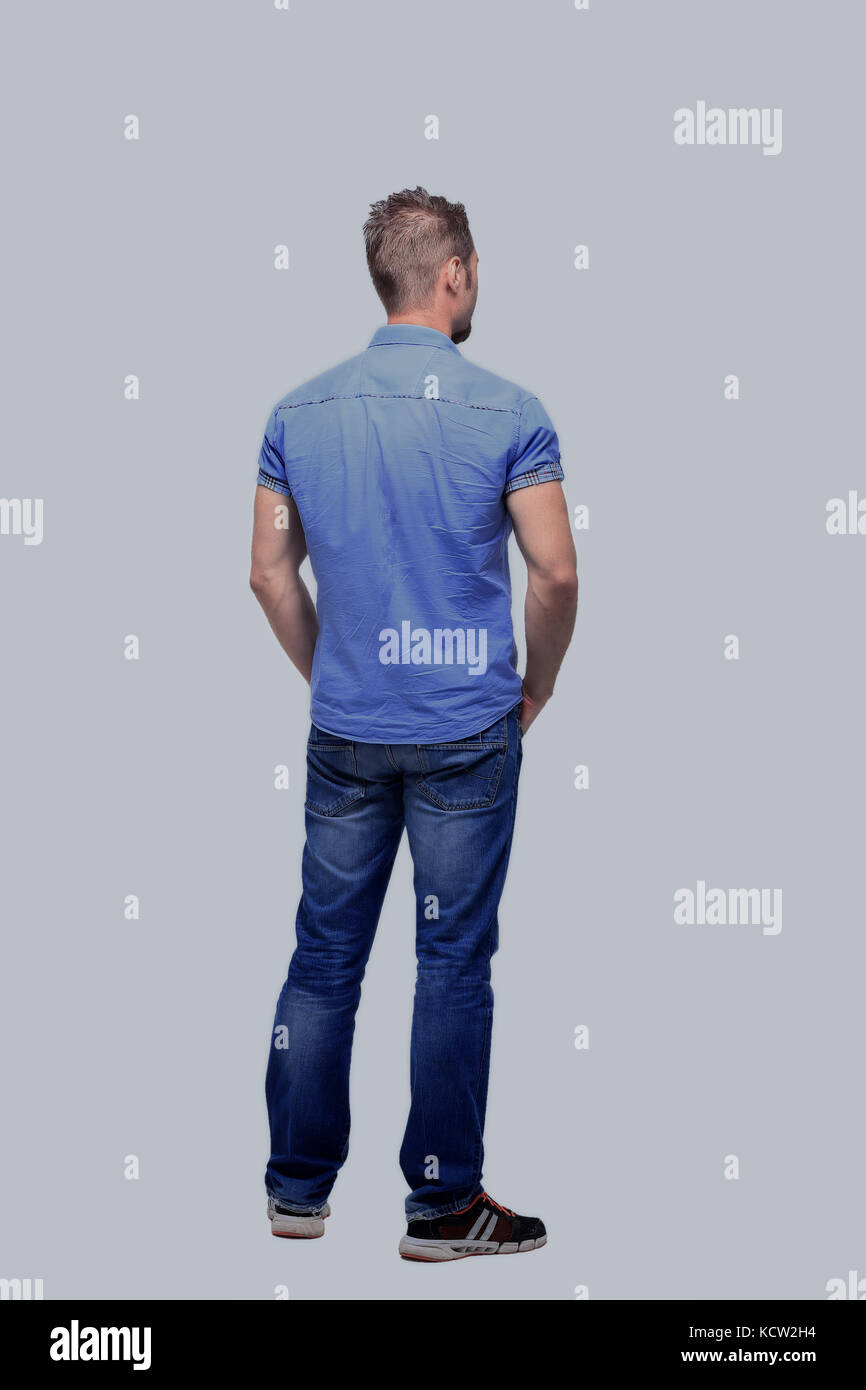 Casual man from the back - looking at something isolated on the white ...