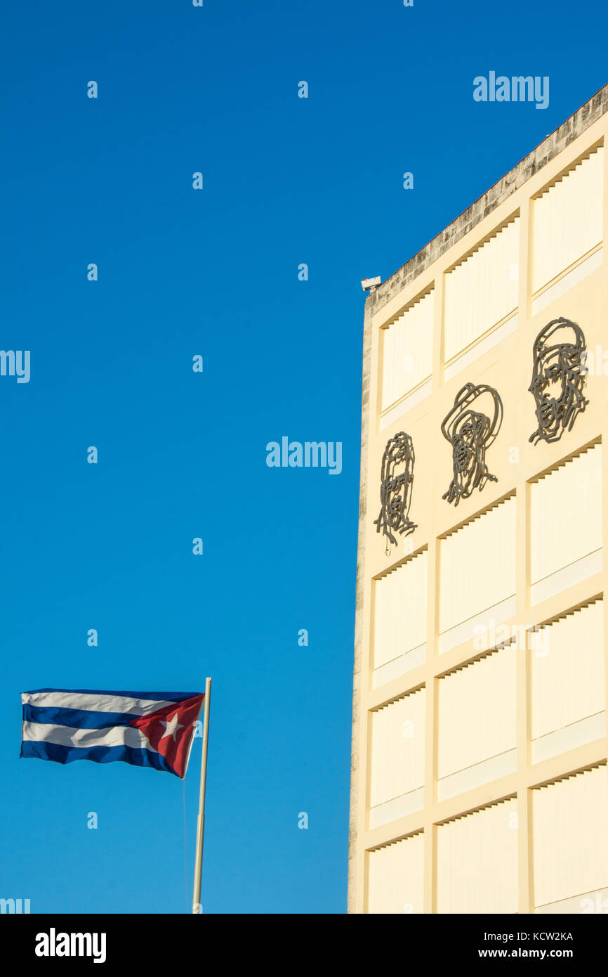 Cuban flag flies beside the offices of the Communist party building ...