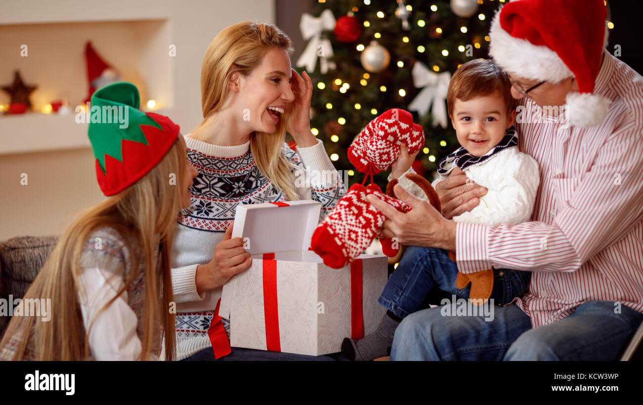 Happy smiling family at Christmas opening gifts together Stock Photo ...
