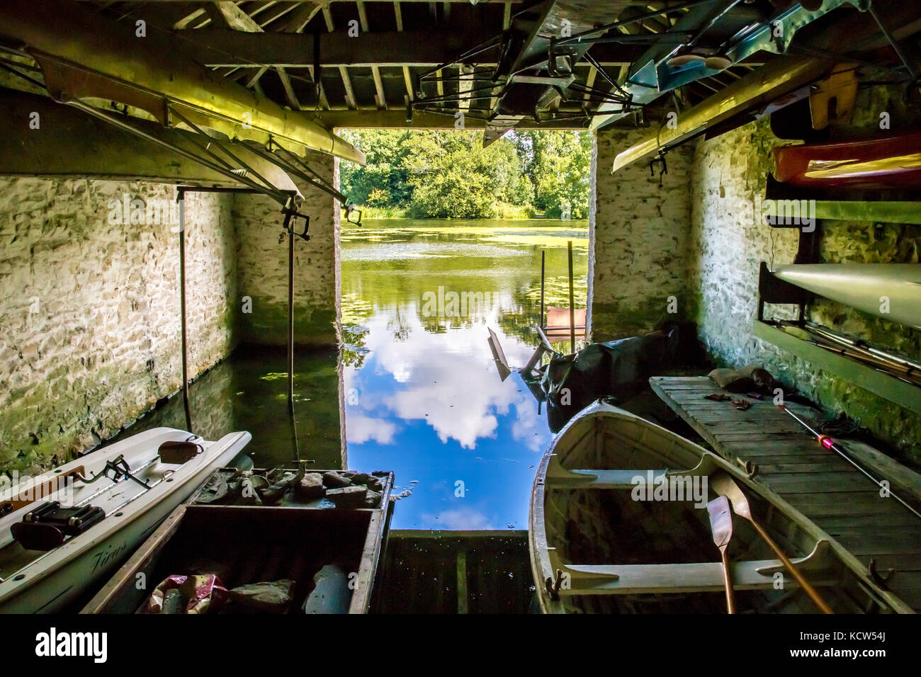 Inside of old boat house with various rowing boats Stock Photo - Alamy