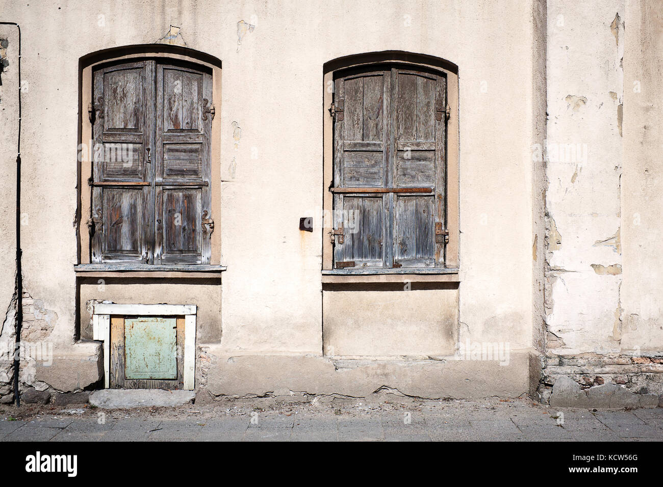 Old grungy wall with closed windows Stock Photo - Alamy