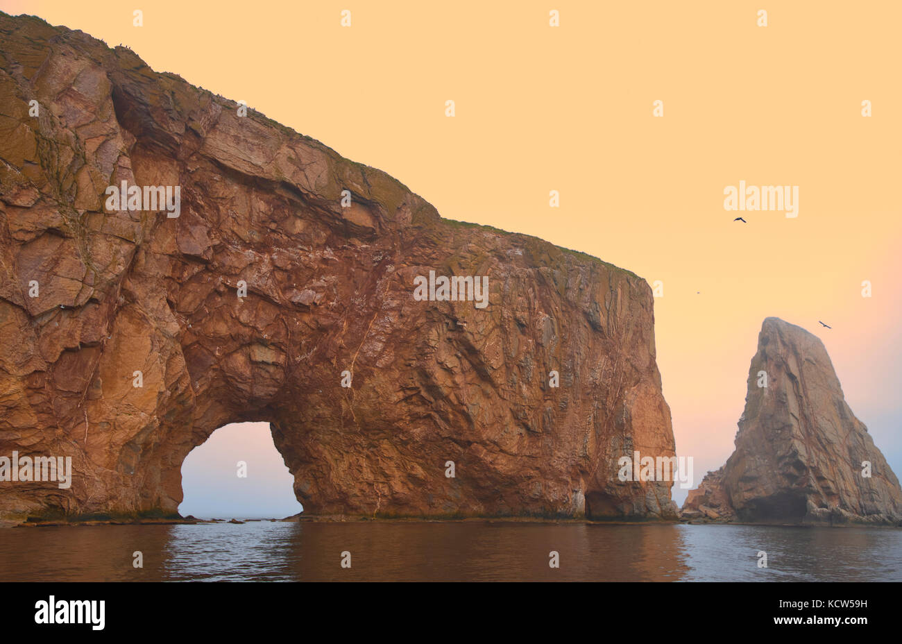 Roche Perce and Atlantic Ocean sin fog at sunrise on Gaspe Peninsula ...